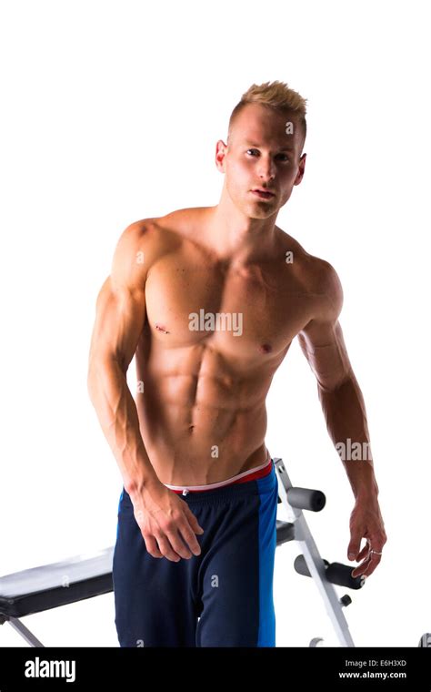 Portrait Of A Handsome Blond Muscular Young Man Next To Gym Bench