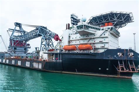 Premium Photo Large Offshore Floating Crane Vessel With Crane And A Helipad Is Moored In The