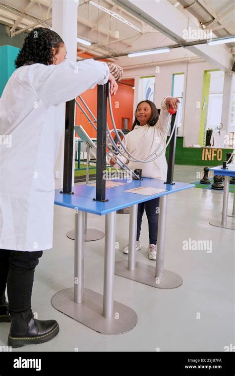 Girl Doing Experiment At Science Center Stock Photo Alamy
