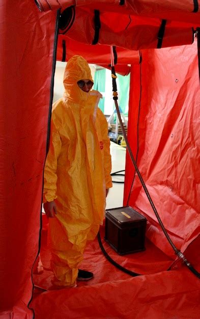 Premium Photo Man Holding Camera While Standing On Bed