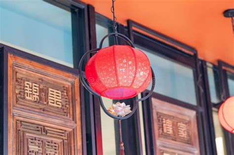 Striking Red Lantern Suspended On The Side Of A Structure Stock Image