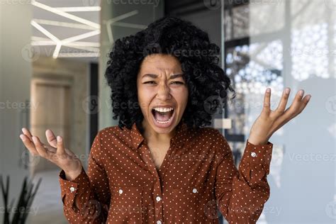 A Young Professional Woman Appears Exasperated And Annoyed While Looking Directly At The Camera