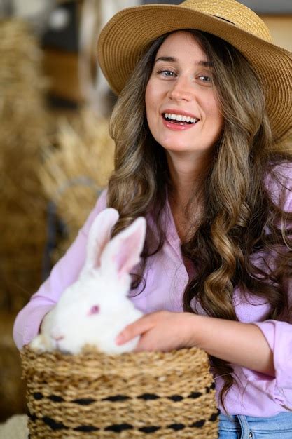 Premium Photo Woman In Pink Shirt Playing With A White Bunny Rabbit