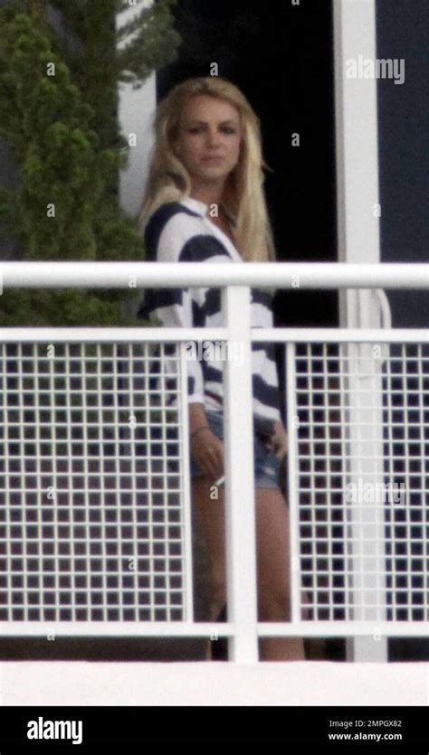 Britney Spears Wearing Daisy Dukes And A Striped Top Relaxes While