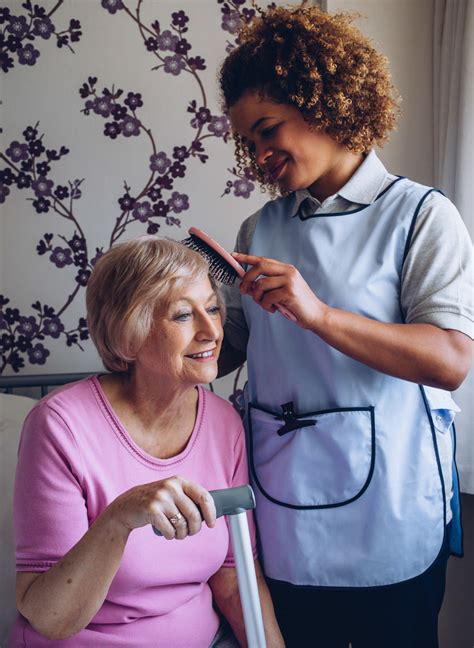Carer Brushing Patients Hair Ginter Hall South Assisted Living And Memory Care