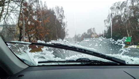 Wipers Clearing Snow From A Car Windshield In Winter Stock Illustration