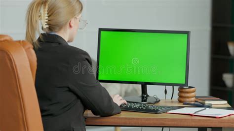 Woman Working On Desktop Computer With Green Screen Mock Up In Creative Office Stock Video