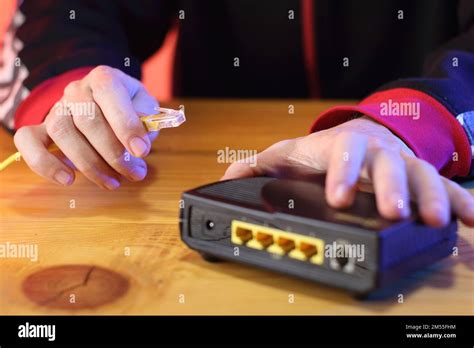 Connecting Internet Cable To Old Adsl Modem On Table By Background