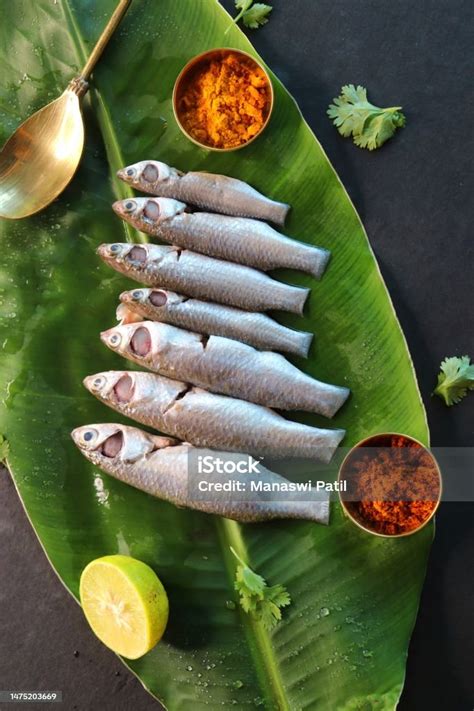 Indian White Mullet Fish Or Boi Fish On Green Banana Leaf With Spices
