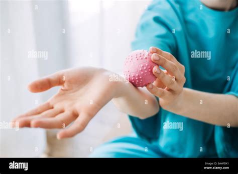 Close Up Of Woman Applying A Pink Massage Ball To Her Forearm Tactile