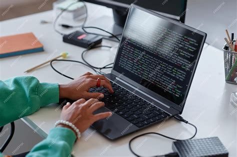 Premium Photo Closeup Of Woman Typing Codes On Laptop While Working At Her Workplace