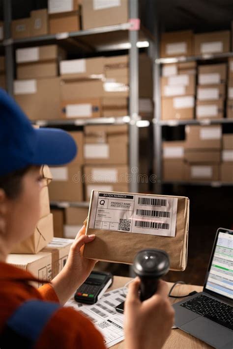 Warehouse Worker Scanning Barcode On Parcel Using Barcode Scanner Preparing Parcels For Shipment