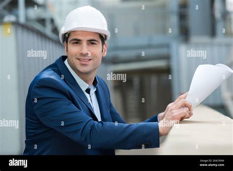Engineer With Blueprint At Building Area Stock Photo Alamy
