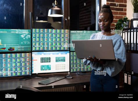 African American Professional Using Her Laptop Focuses On Researching Trading Strategies Young