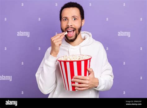 Photo Of Young Funny Latin Guy Wear White Stylish Hoodie Pop Corn Snack
