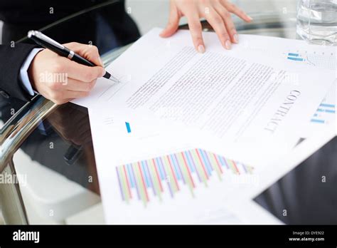 Image Of Female Hand Signing Document At Workplace Stock Photo Alamy