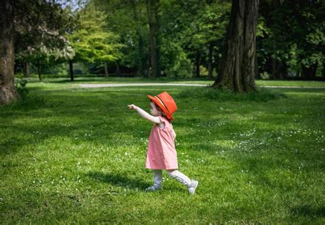 Premium Photo Portrait Of A Girl In A Red Belgian Flag Hat In The Park