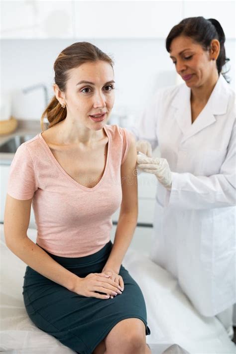 Young Woman Getting Injection At Doctors Office Stock Image Image Of