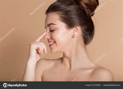 Happy Smiling Girl With Perfect Skin With Moisturizing Face Cream On A