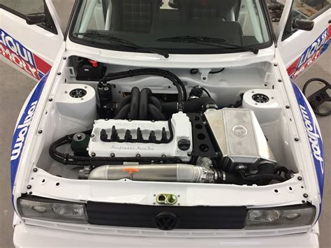 Engine Compartment Of A White Volkswagen Golf Gti