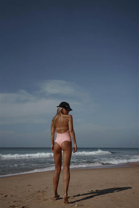 Back View Of A Person In A Pink Swimsuit Standing At The Beach · Free
