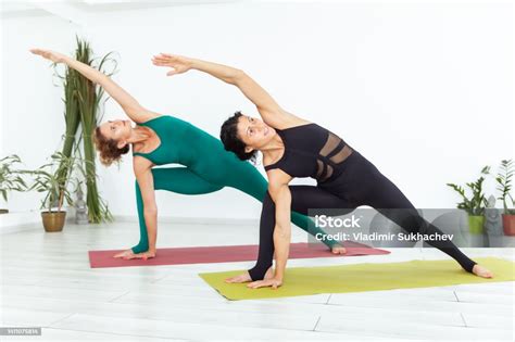 Two Beautiful Women Yogis Together Practice Yoga Asana Pose In Yoga