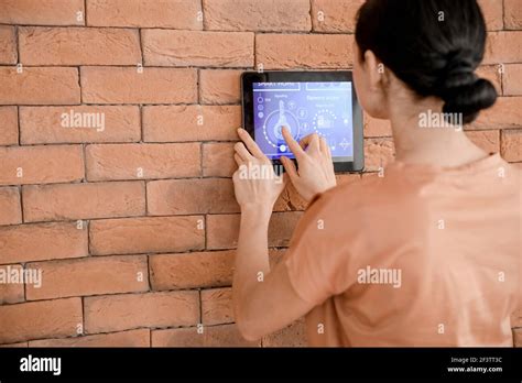 Woman Using Smart Home Security System Control Panel Stock Photo Alamy