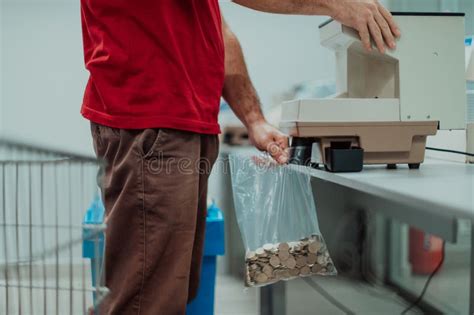 Bank Employees Using Money Counting Machine While Sorting And Counting Small Iron Banknotes