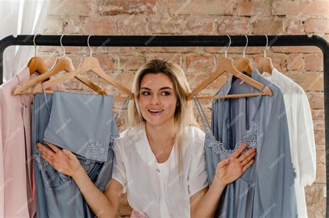 Premium Photo Young Beautiful Woman And Clothing Rack With Different