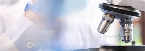 Scientist Analyzing Microscope Slide At Laboratory Technician