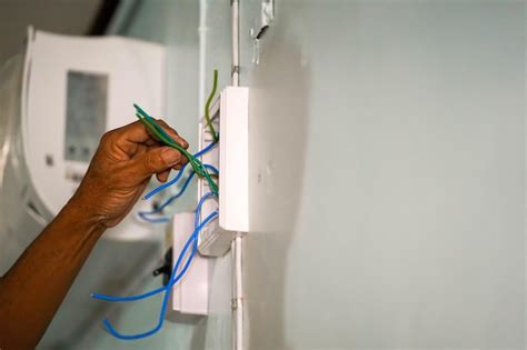 Premium Photo Closeup Hands Of Electrician Connecting Electrical Equipment And Wiring Within