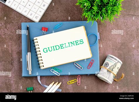 Guidelines Concept Guidelines Word Written On A Blank Sheet Of A Notebook View From Above