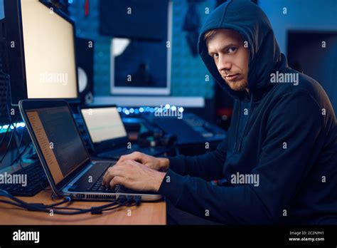 Hacker In The Hood Sitting At Laptop Information Hacking Internet Spy Male Programmer Trying