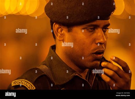 Security Personnel Patrol A Crowded Area At Night During A Significant