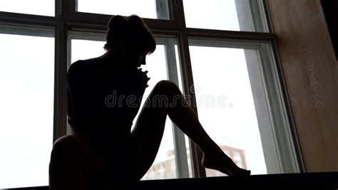 Woman On Window Sill Silhouette Against Window Naked Woman Is Sitting