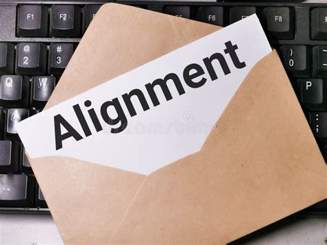 Text ALIGNMENT Written On White Paper Note In The Envelope On Computer Keyboard Stock Photo