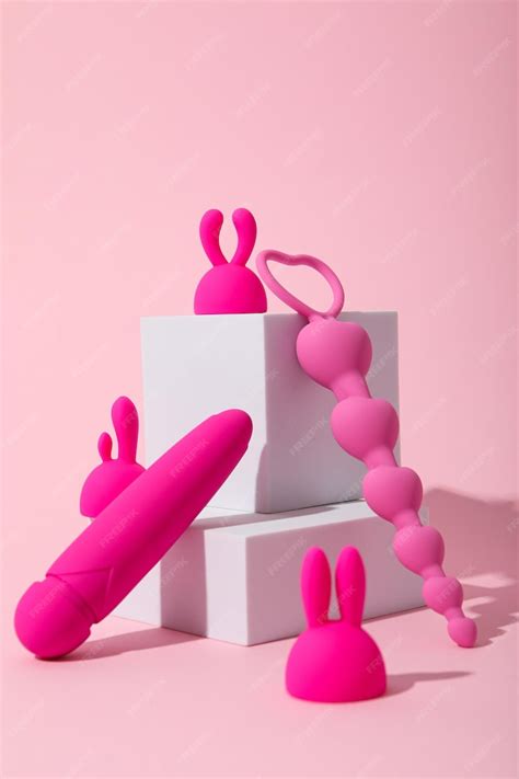 Premium Photo Composition Of Pink Sex Toys With Cubes On A Pink