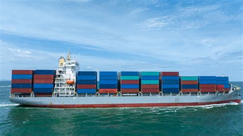 Side View Of Cargo Container Ship On Beautiful Blue Sky Container
