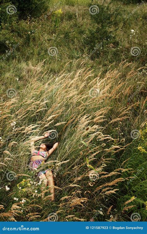Beautiful Woman Hipster Lying In Grass In Summer Meadow And Relaxing