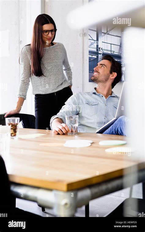 Colleagues In Office Using Laptop Stock Photo Alamy