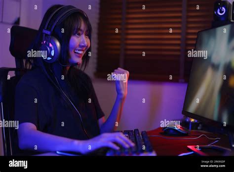 Female Cyber Hacker Gamer Watching Monitor And Making Win Gesture After