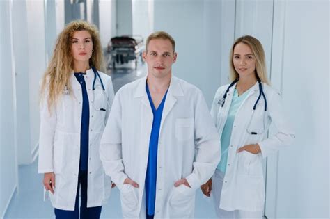 Premium Photo A Team Of Doctors Of Different Genders Who Are Standing Inside The Clinic In The