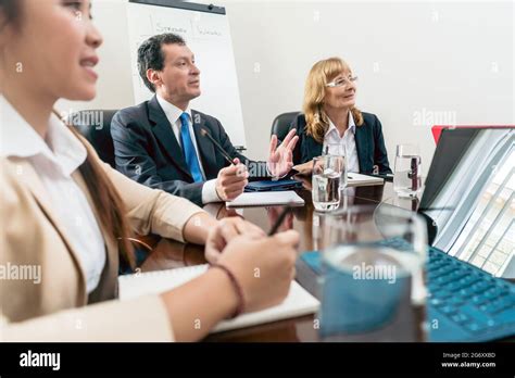 Male And Female Senior Managers Sitting Down During An Important Interactive Meeting In The