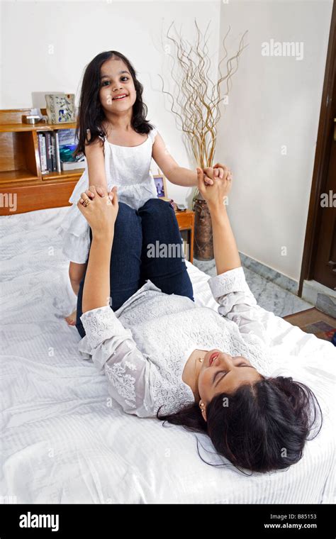 Girl Playing With Her Mother Stock Photo Alamy