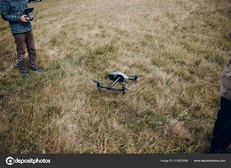 Man Pilot Controlling Quadcopter Drone With Remote Controller Pad