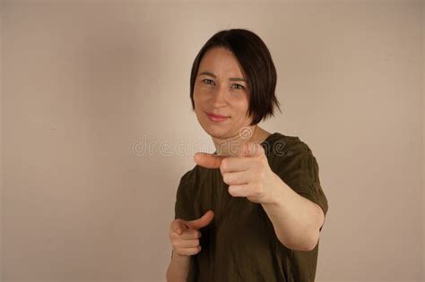 Portrait Of A Happy Girl Pointing Her Finger At The Camera Close Up