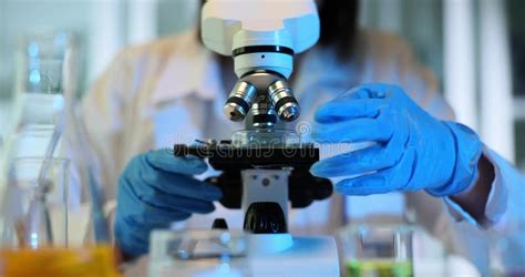 Medic Puts Glass Slide With Specimen On Microscope In Lab Stock Footage