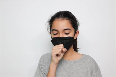 Premium Photo Girl Wearing Pollution Mask Coughing Against White