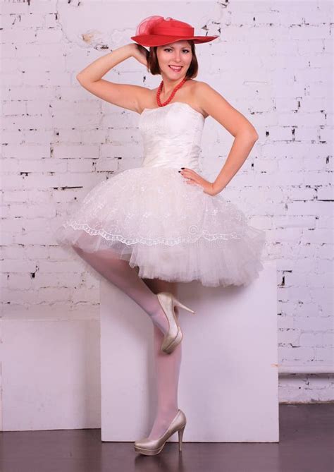 Beautiful Long Legged Bride In Wedding Dress And White Stockings Posing