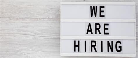 우리는 고용하고 있다 흰색 나무 표면에 현대 보드에 단어 상단 보기 오버 헤드 위에서 평평한 누워 공간을 복사합니다 구인 중에 대한 스톡 사진 및 기타 이미지 Istock